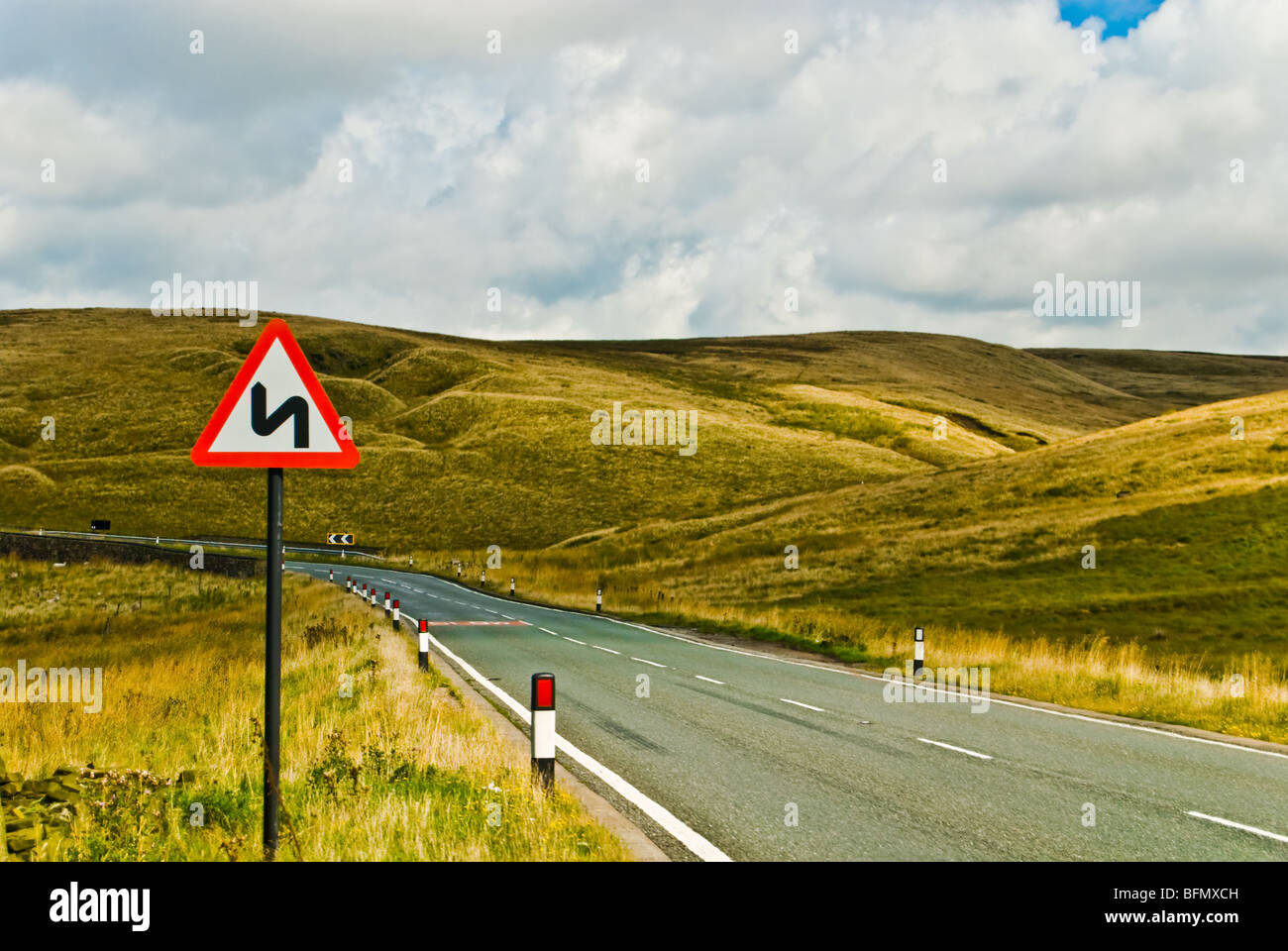 Double bend road sign against white clouds on Lancashire/Yorkshire ...