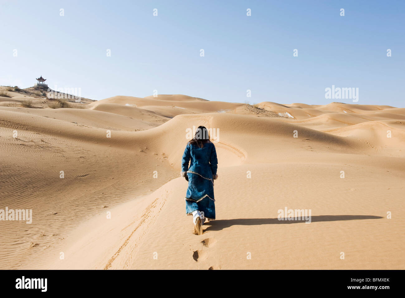 China, Ningxia Province, Shapotou, a girl walking in the sand, Tengger ...