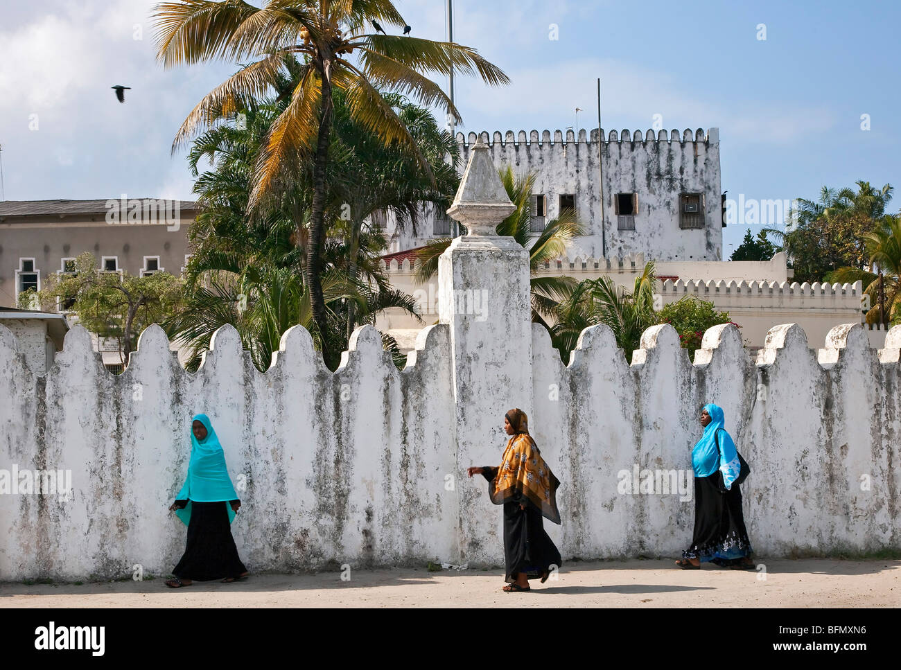 Tanzania, Zanzibar, Stone Town. Zanzibari women walk along Mzingani ...