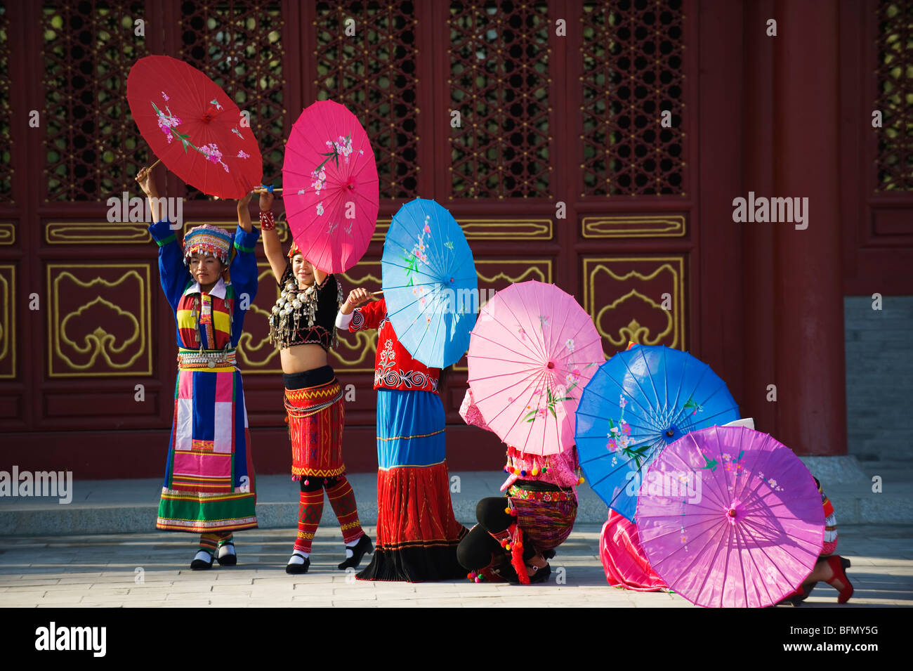 China, Beijing, Ethnic Minorities Park, girls dancing with parasols ...