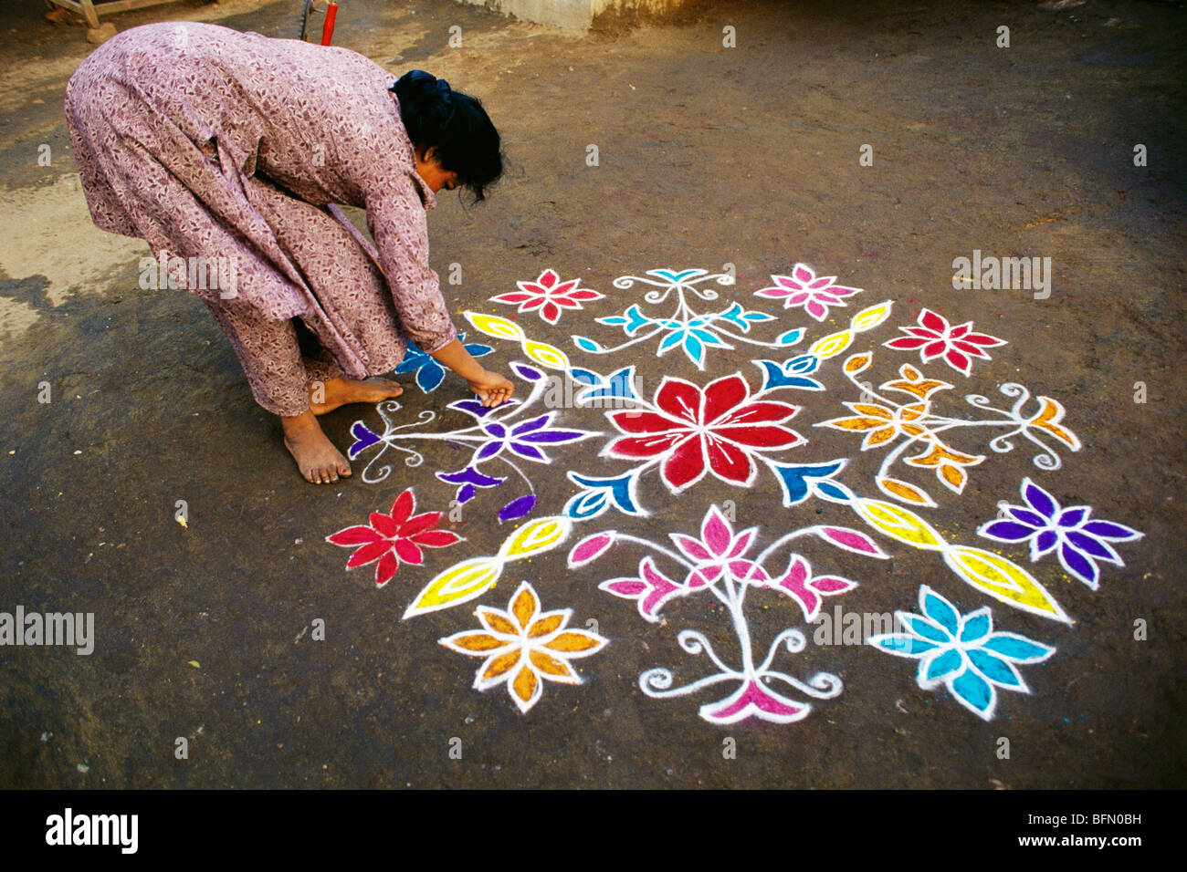 Lady doing rangoli work near Hospet ; Karnataka ; India Stock Photo - Alamy