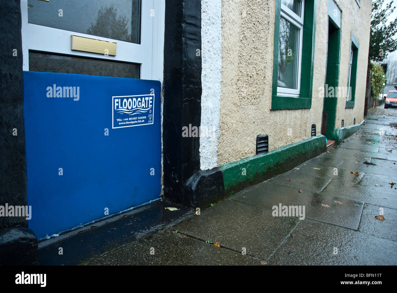 Floodgate barrier protecting a front door from floods in Eamont Bridge ...
