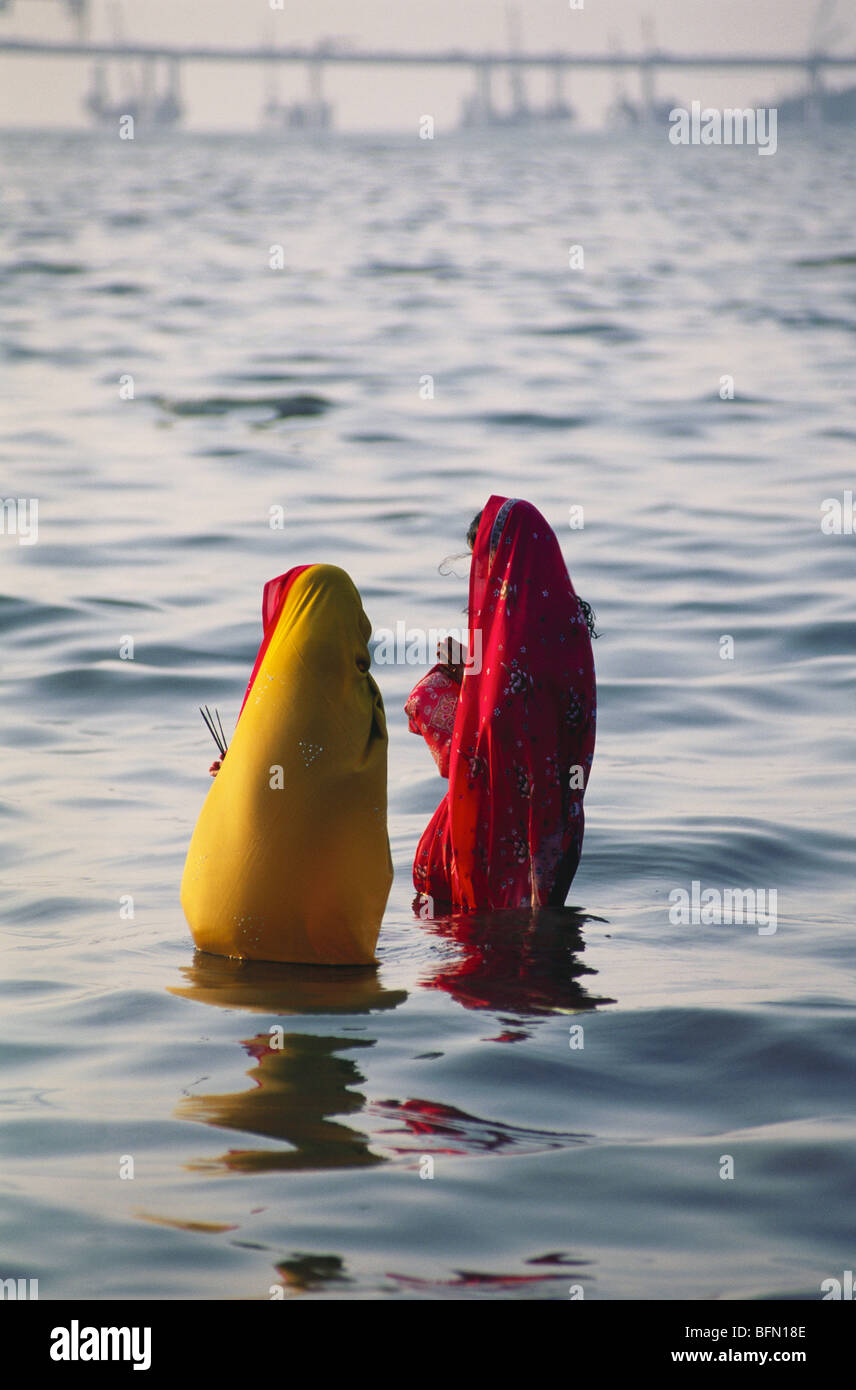 Bihari women praying standing in sea ; Chhath puja festival ; Dadar ...