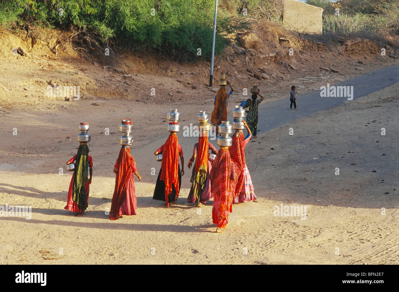 Women balancing water pots on head ; Bhuj ; Kutch ; Gujarat ; India ...
