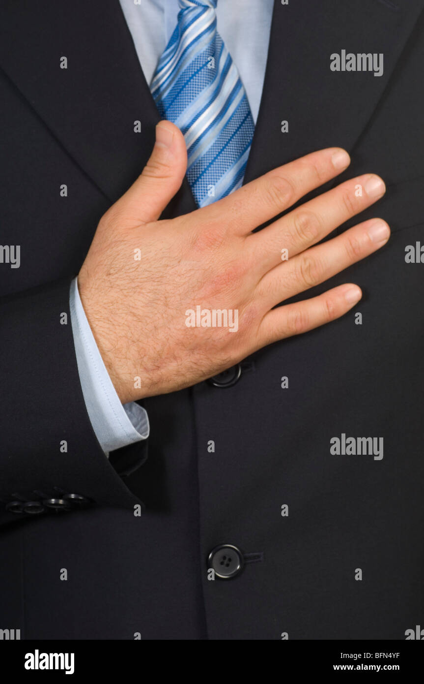 Business man hand over chest Stock Photo - Alamy