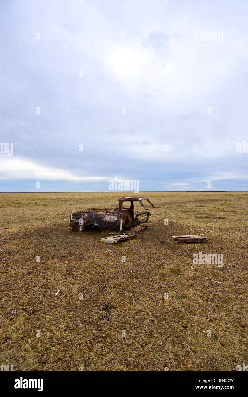 The wreck of an antique car rusting away on a drought-stricken farm ...