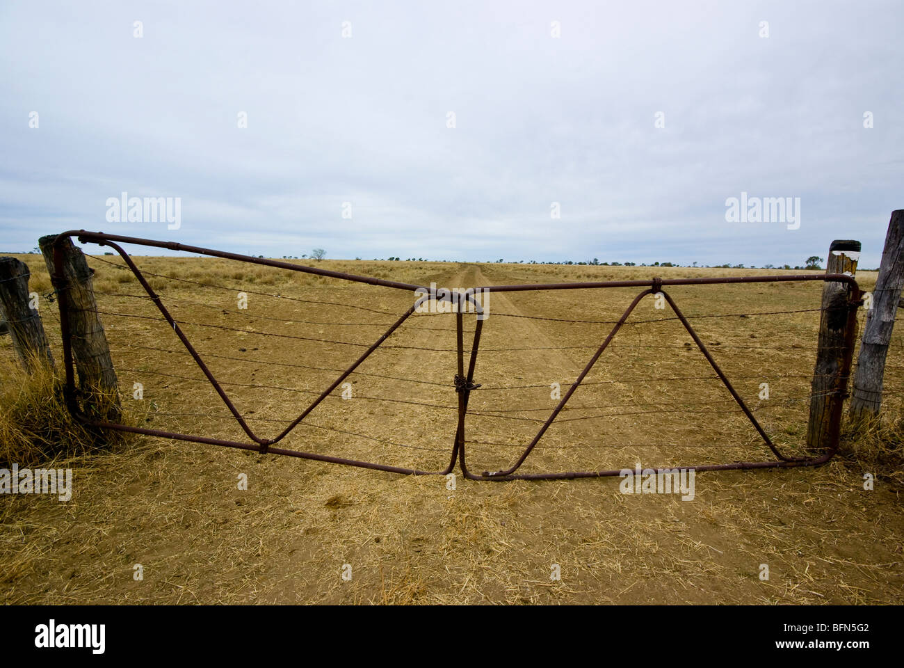 Old rusting gates bar the way through farmland on a featureless plain ...