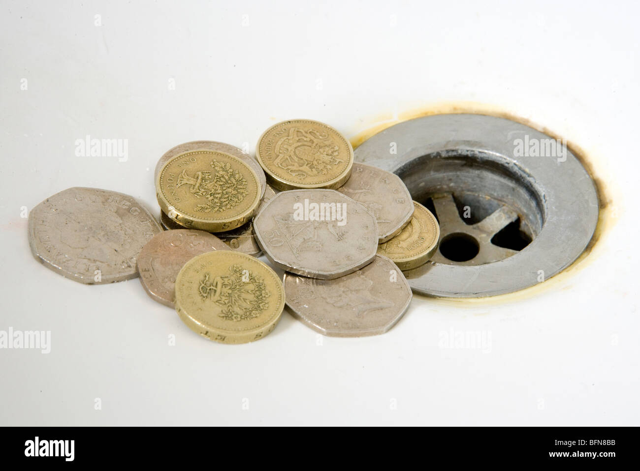 English money going down drain hi-res stock photography and images - Alamy