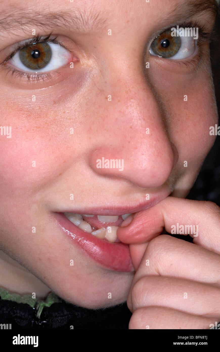 young boy biting his fingernails Stock Photo - Alamy