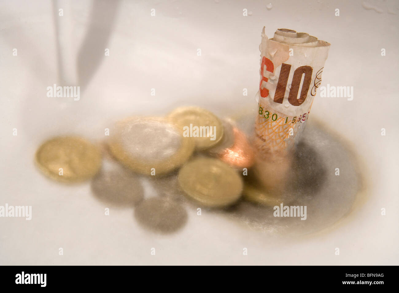 Throwing money down the drain hi-res stock photography and images - Alamy