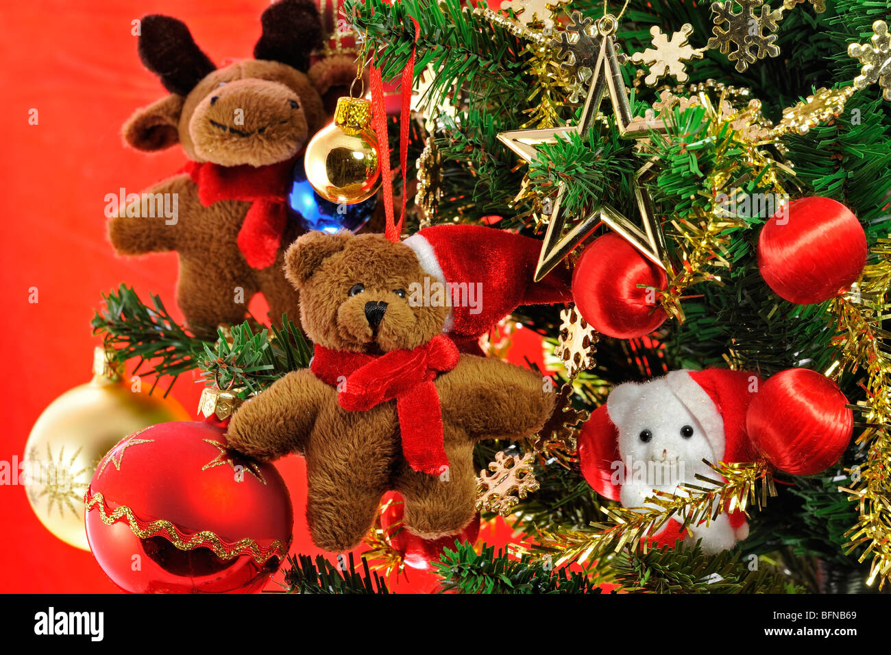 Teddy bear dolls and bells hanging in Christmas tree Stock Photo - Alamy