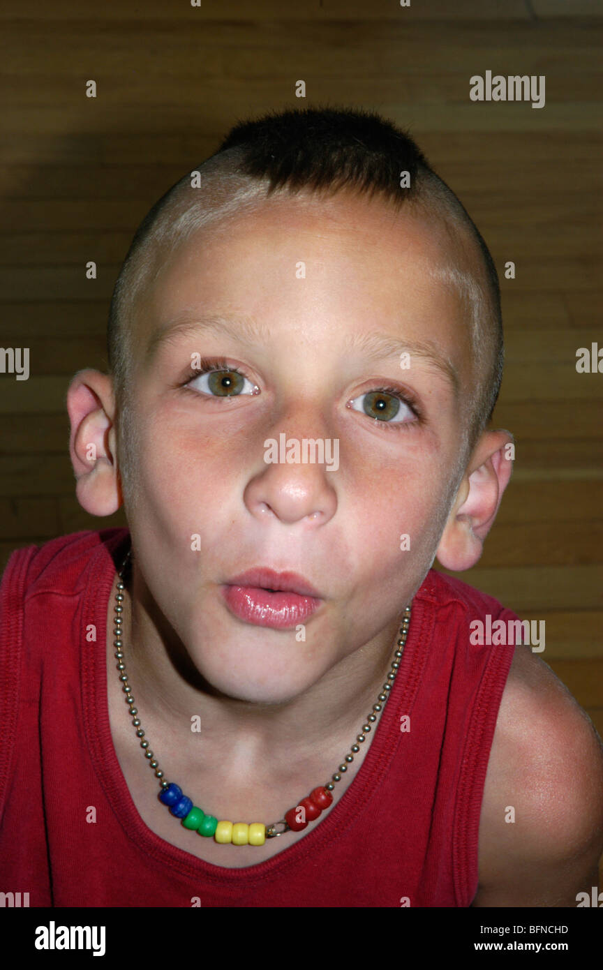 Young boy with autism looking into the camera Stock Photo - Alamy