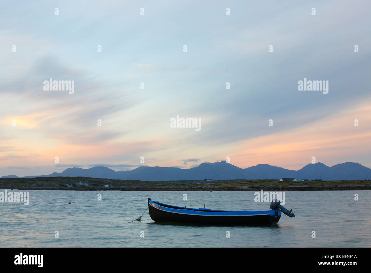 fishing boat at the coast in Carna with view to Island Inishnee and the ...