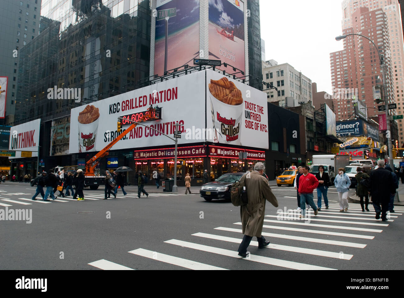 Workers put the finishing touches on a billboard for Kentucky Fried ...