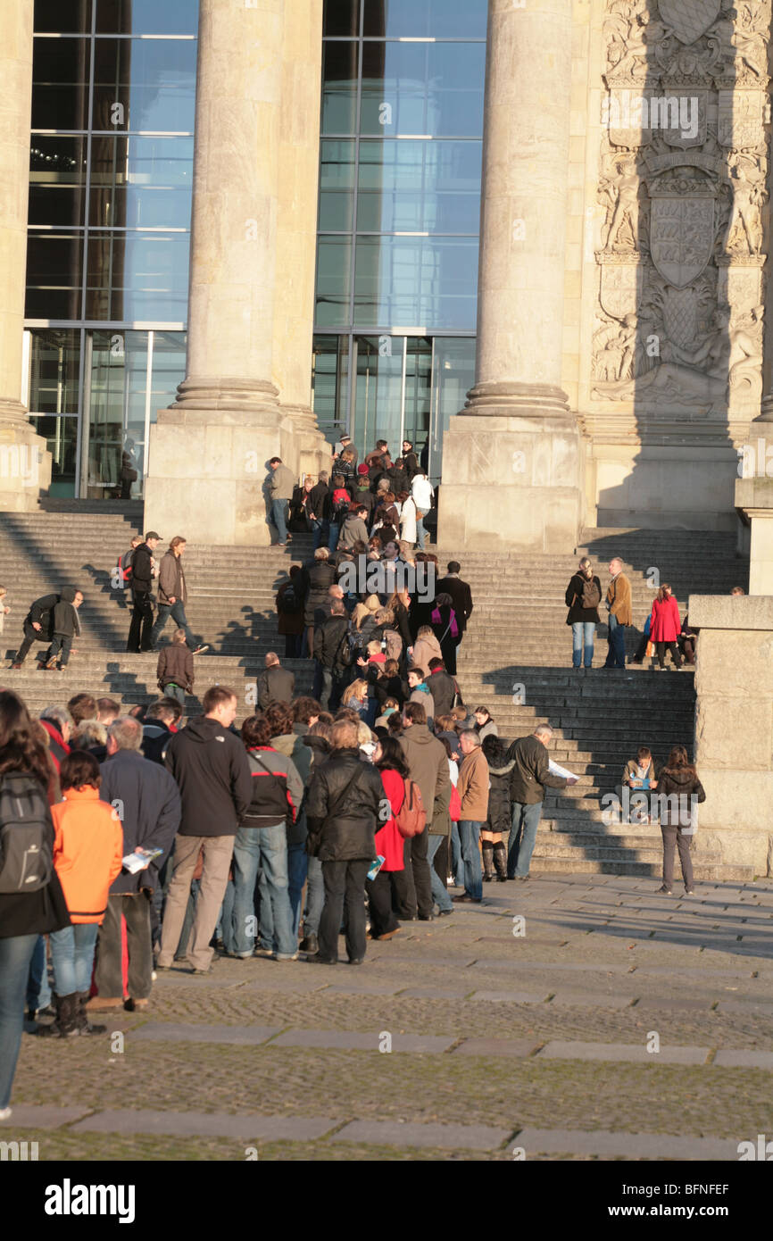 Queue of visitors tourists waiting to enter The Reichstag Berlin ...
