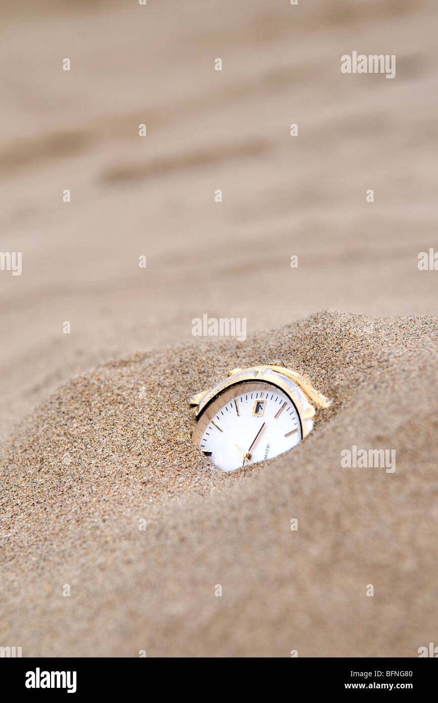 Buried watch in sand taken to depict the sands of time concept Stock ...