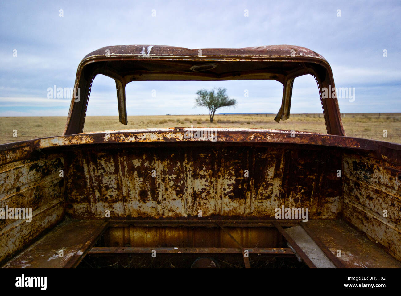 The wreck of an antique car rusting away on a drought-stricken farm ...