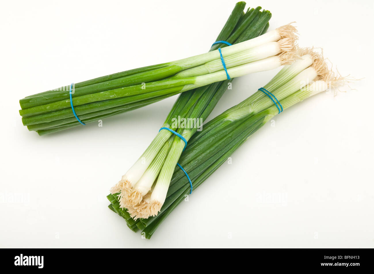 Three bunches of fresh, green onions Stock Photo - Alamy