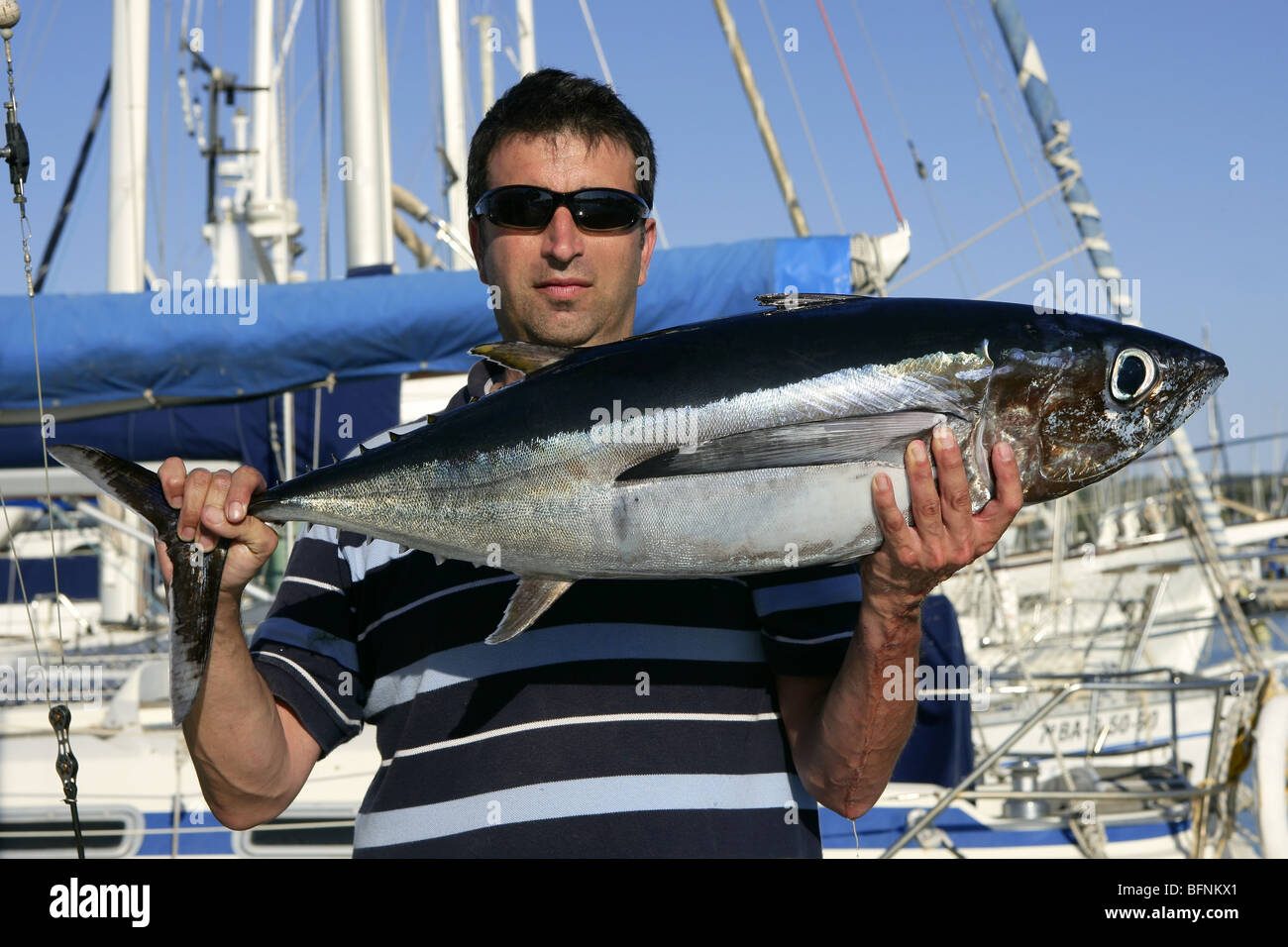 Big game fisherman with saltwater tuna catch in his hands Stock Photo ...