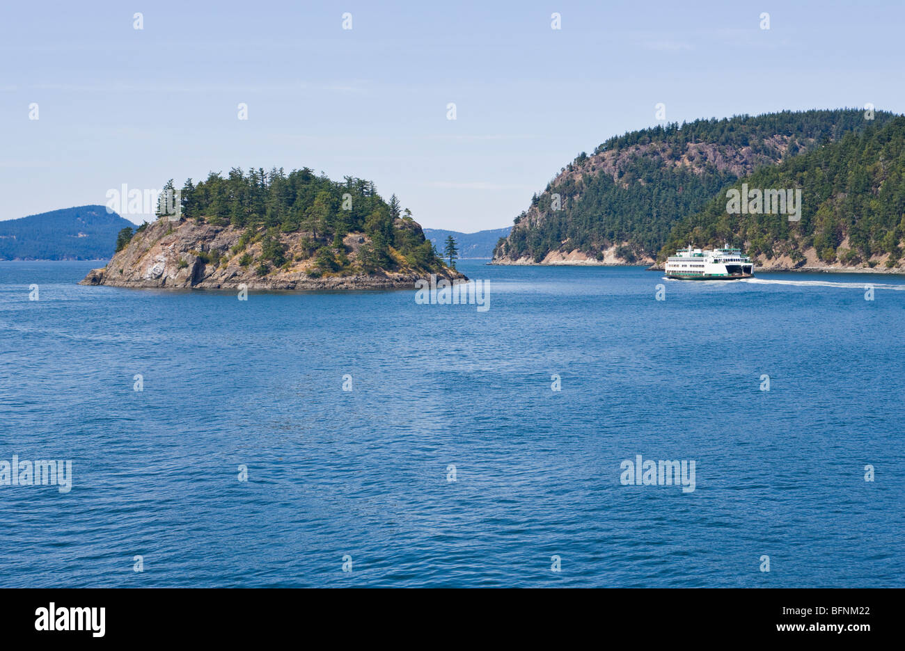 A washington State ferry cruises between two islands in the San Juan ...