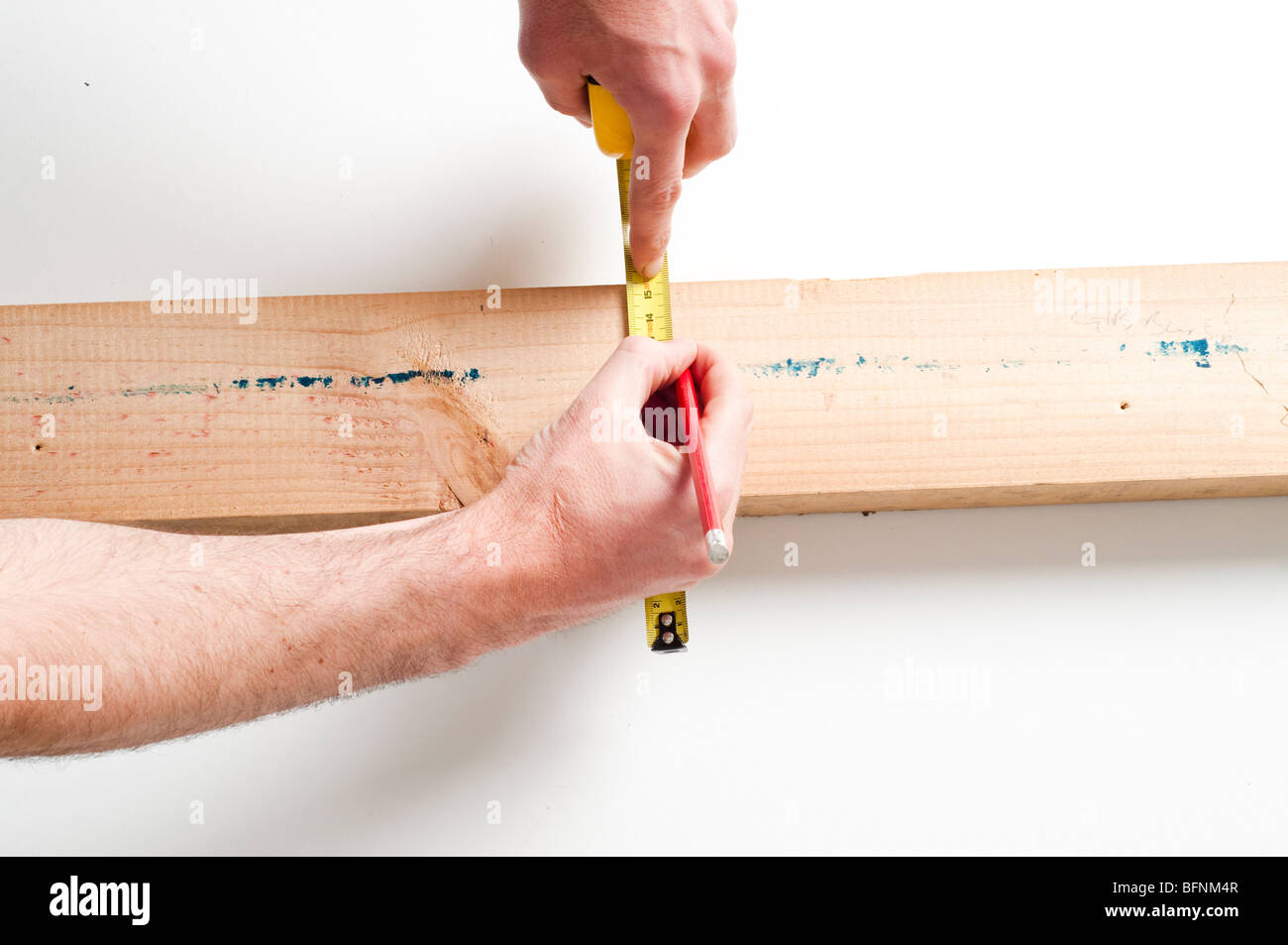 man measuring wood with tape measure and marking with pencil Stock ...