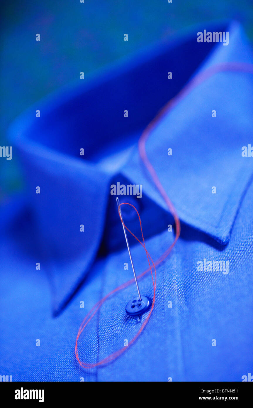 Sewing button on shirt hi-res stock photography and images - Alamy