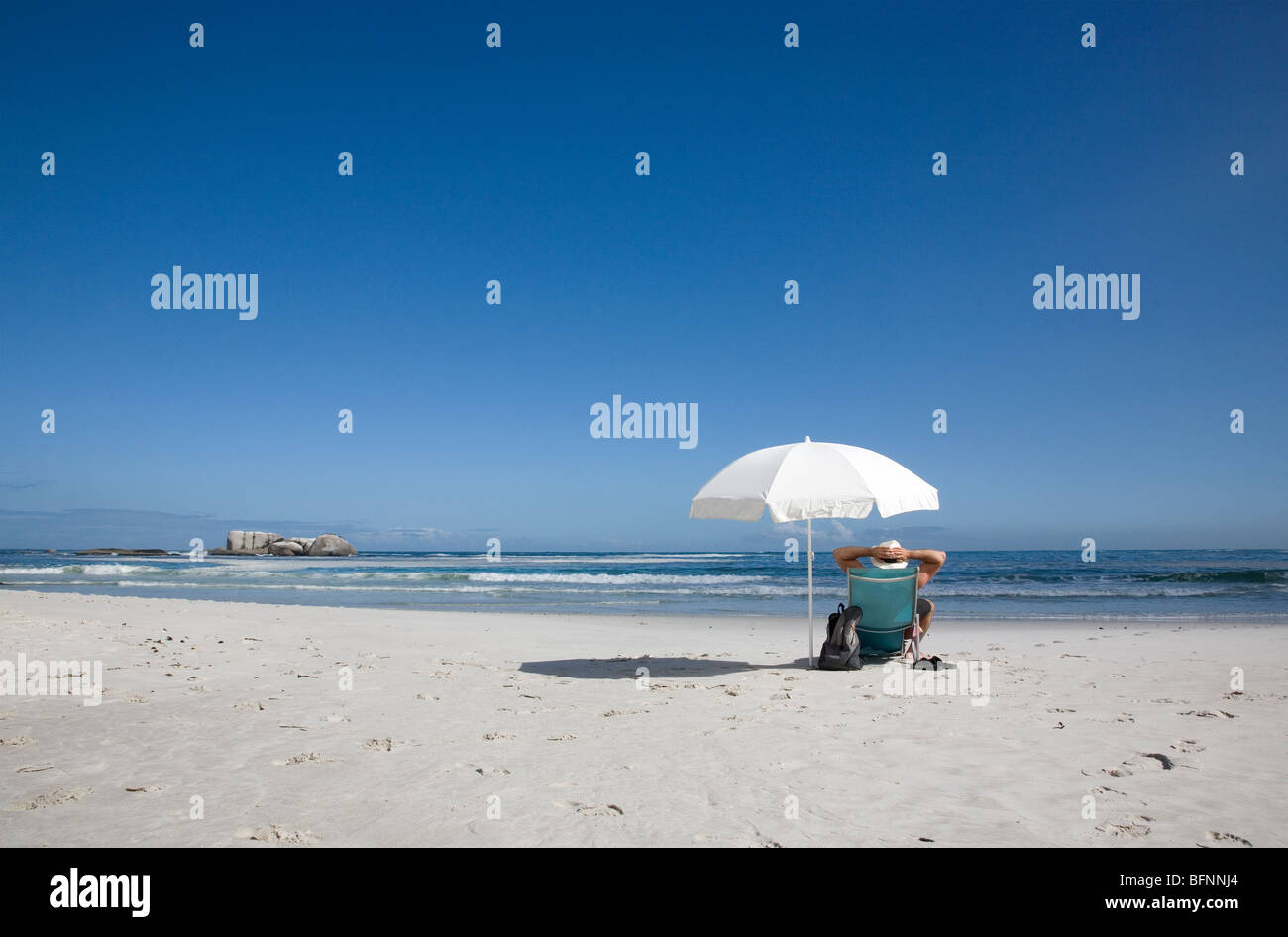 Man lying under umbrella on beach Stock Photo - Alamy Man lying under umbrella on beach Stock Photo - Alamy