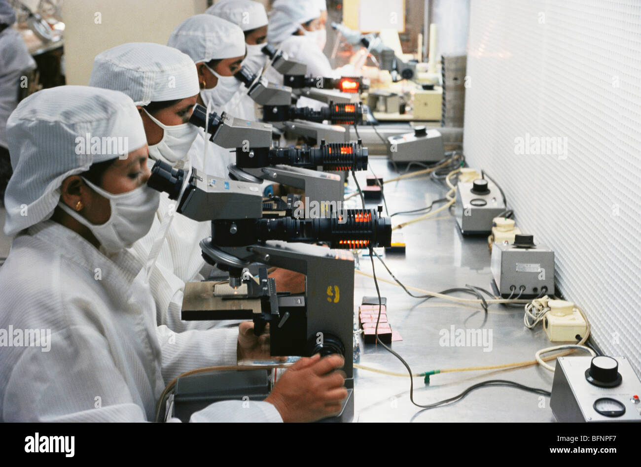 Women looking through microscope equipment Electronics factory India ...