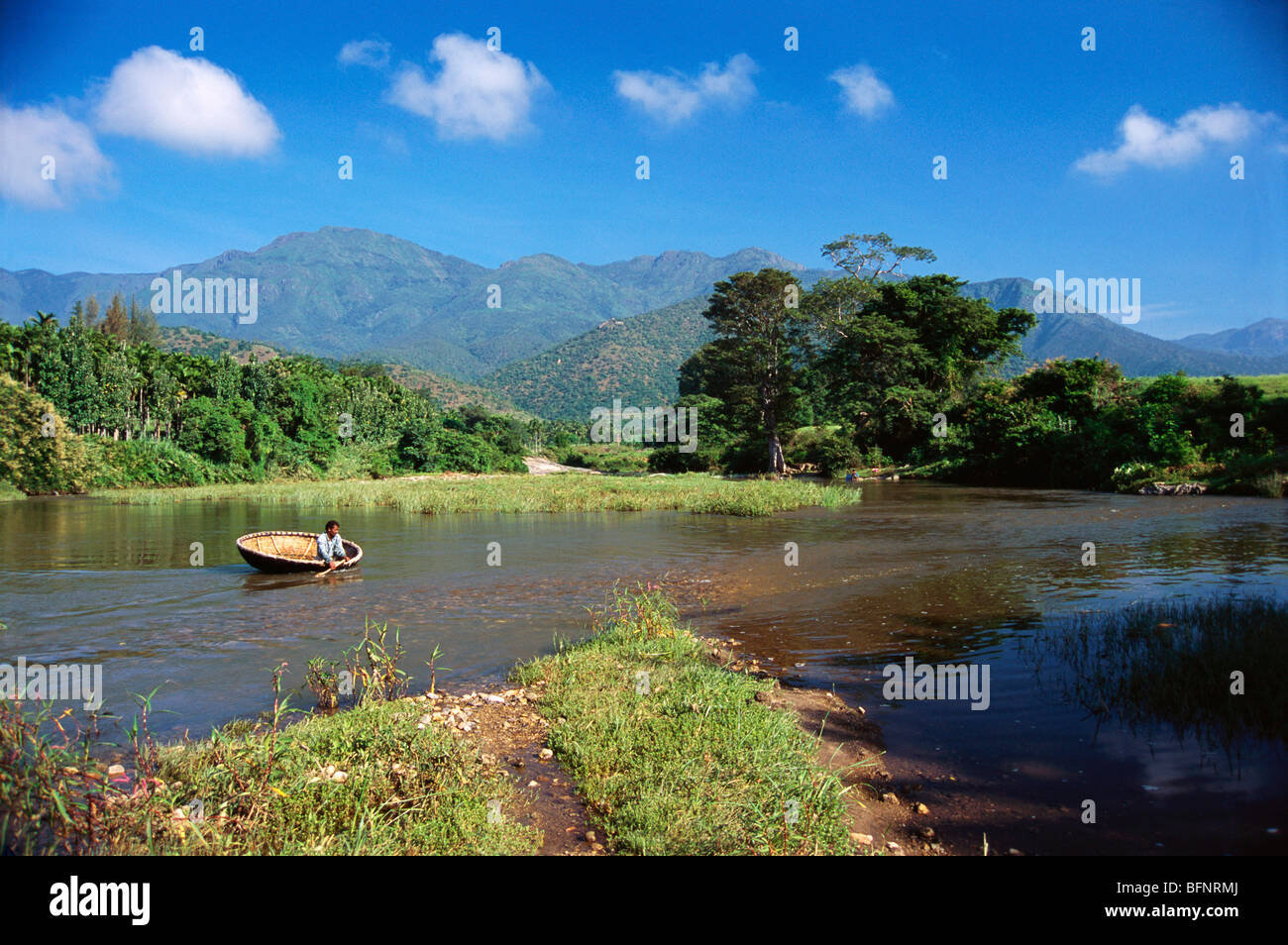 Man fishing in coracle boat ; Kaveri river ; Karnataka ; India ; asia ...
