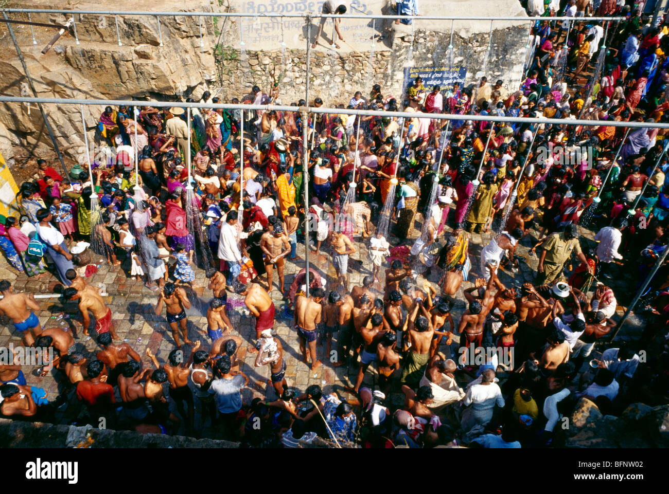 People bathing below taps ; Yellamma Devdasi fair ; Saundatti temple ...