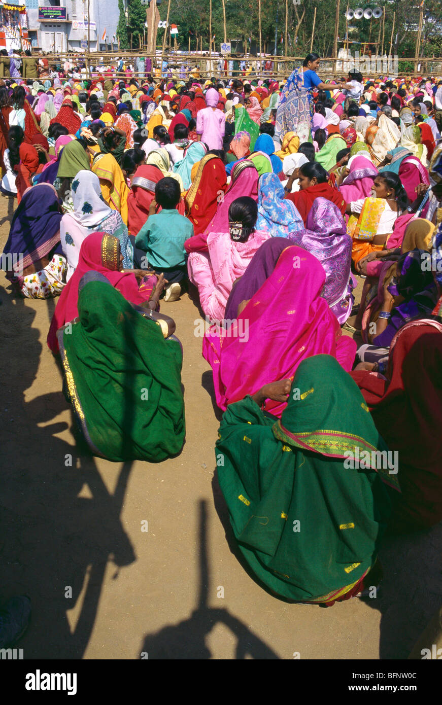Women wearing colorful sarees sitting as crowd in election rally ...