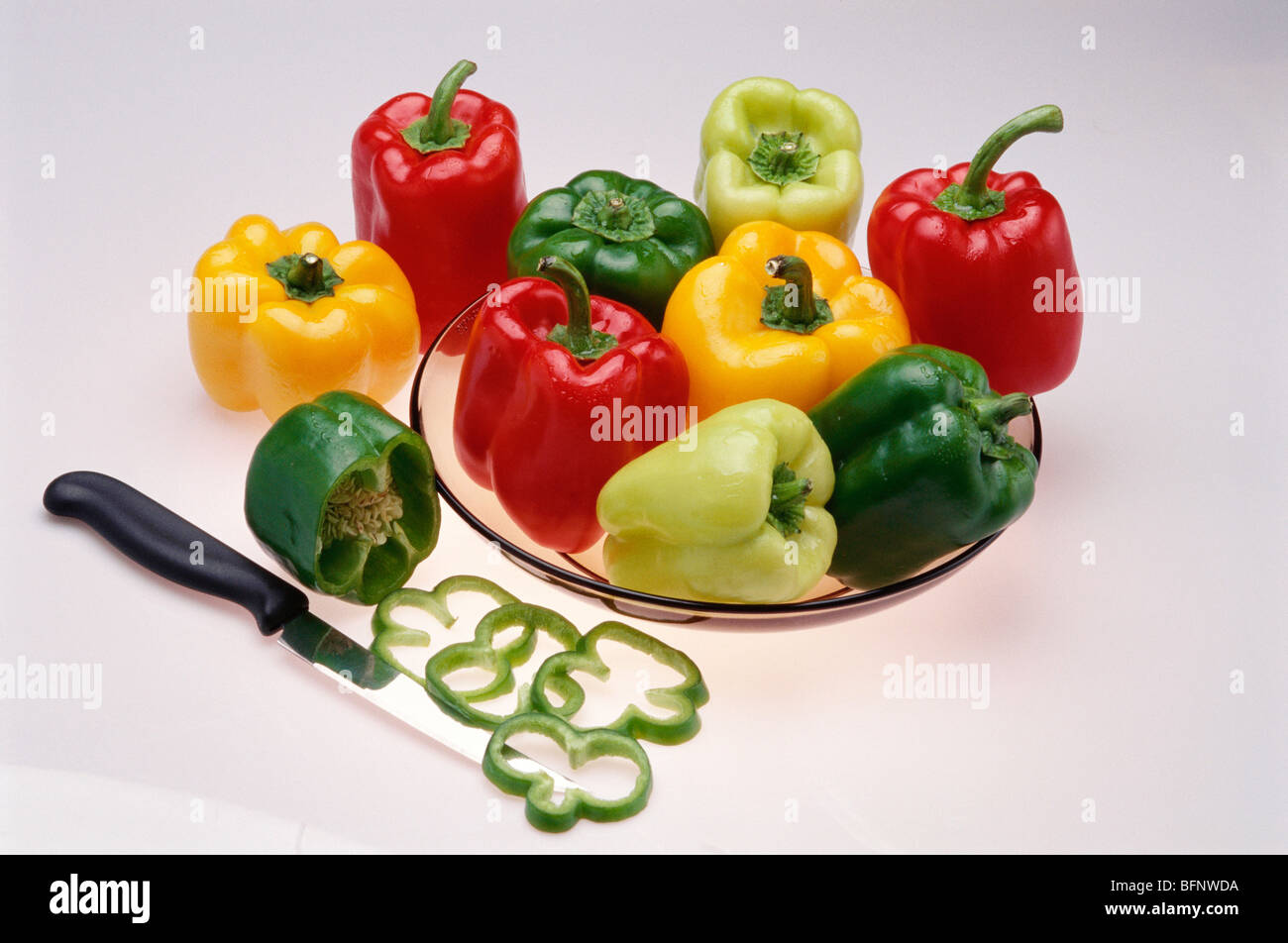 colorful red green yellow capsicum and slices on white background Stock ...