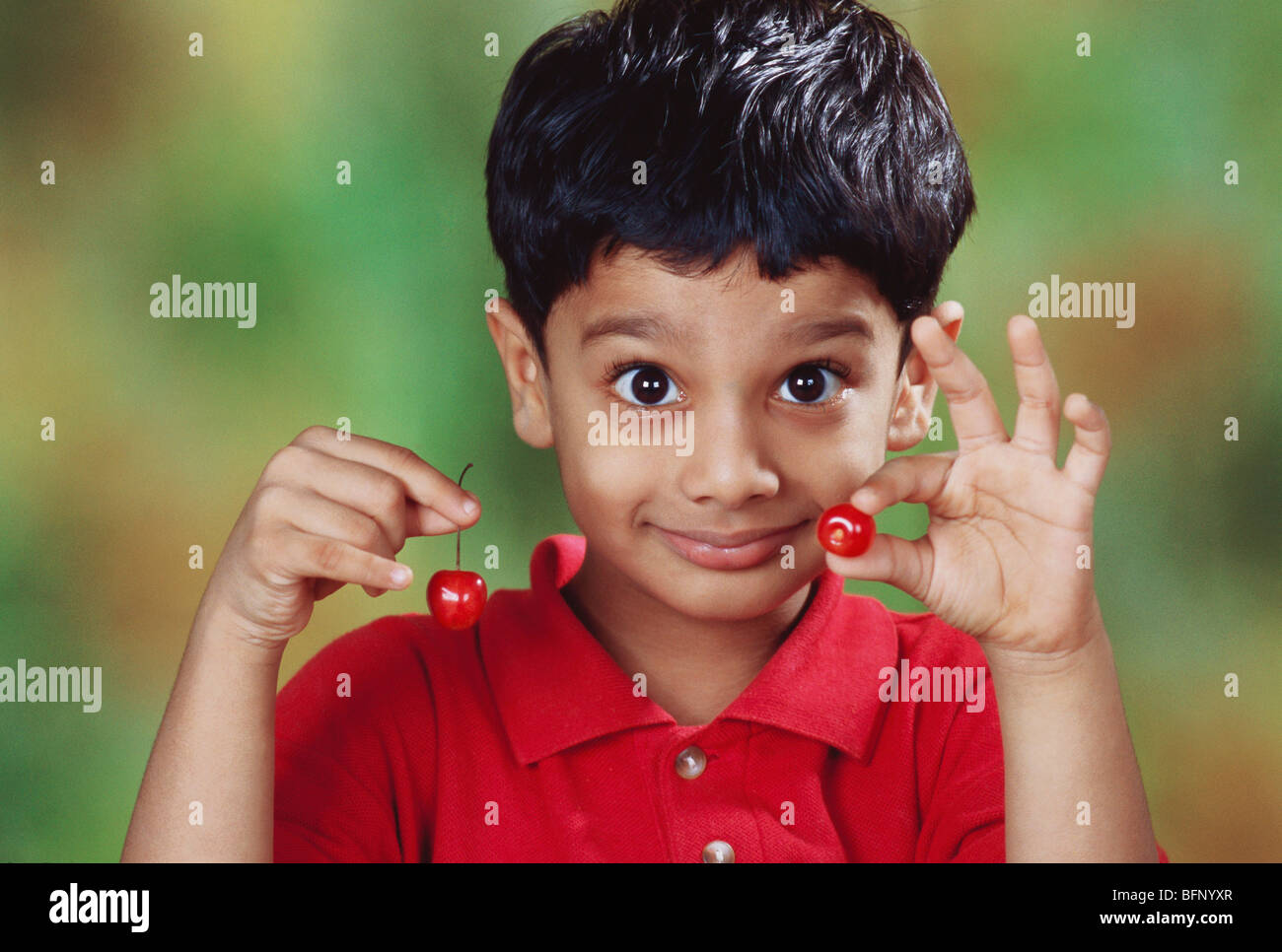 Boy holding red cherries fruit in hand ; India ; asia ; MR#152 Stock ...