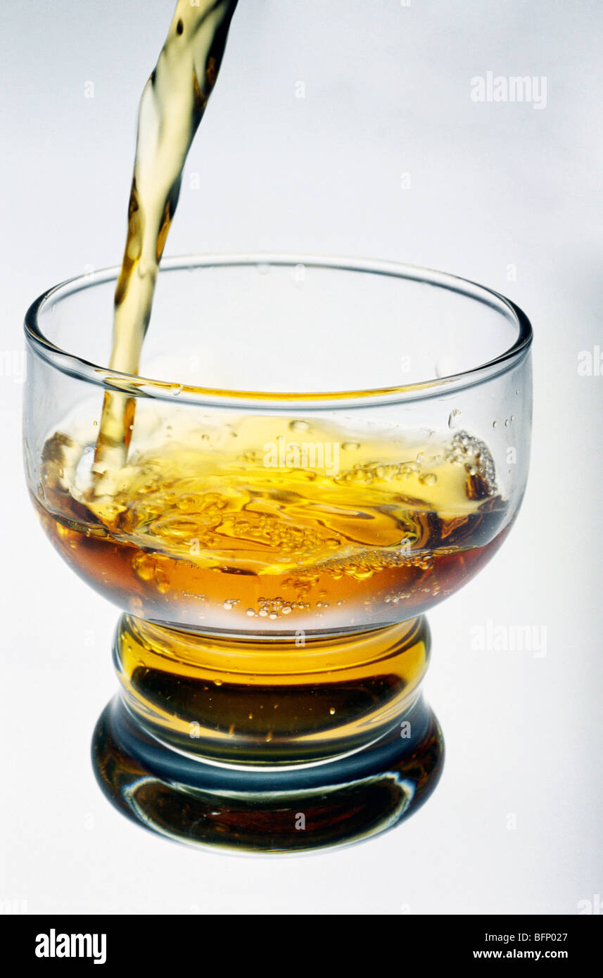 Pouring alcohol in glass Stock Photo - Alamy