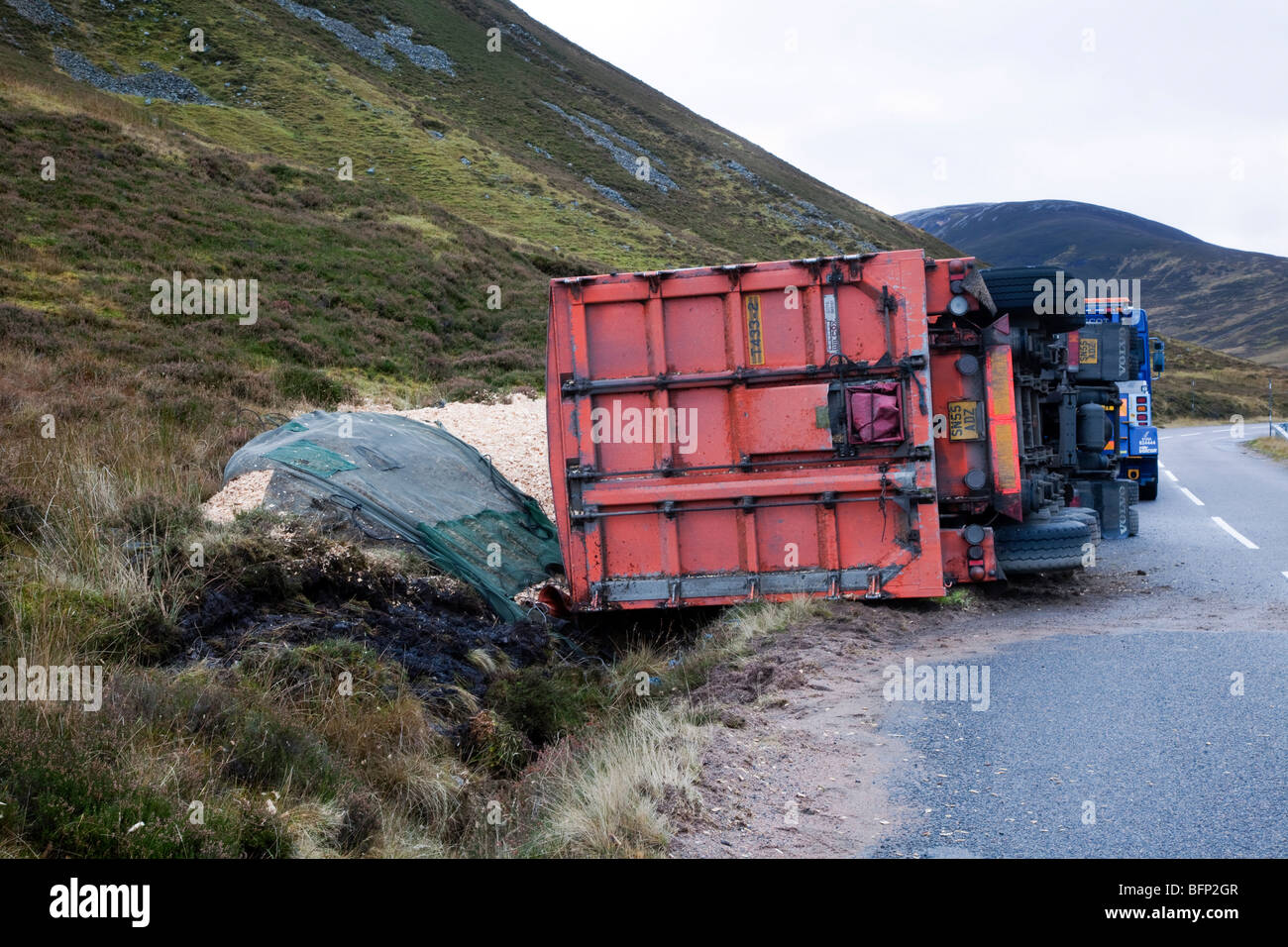 Overturned Heavy Goods Wood Lorry spilling forestry saw mill waste bulk ...