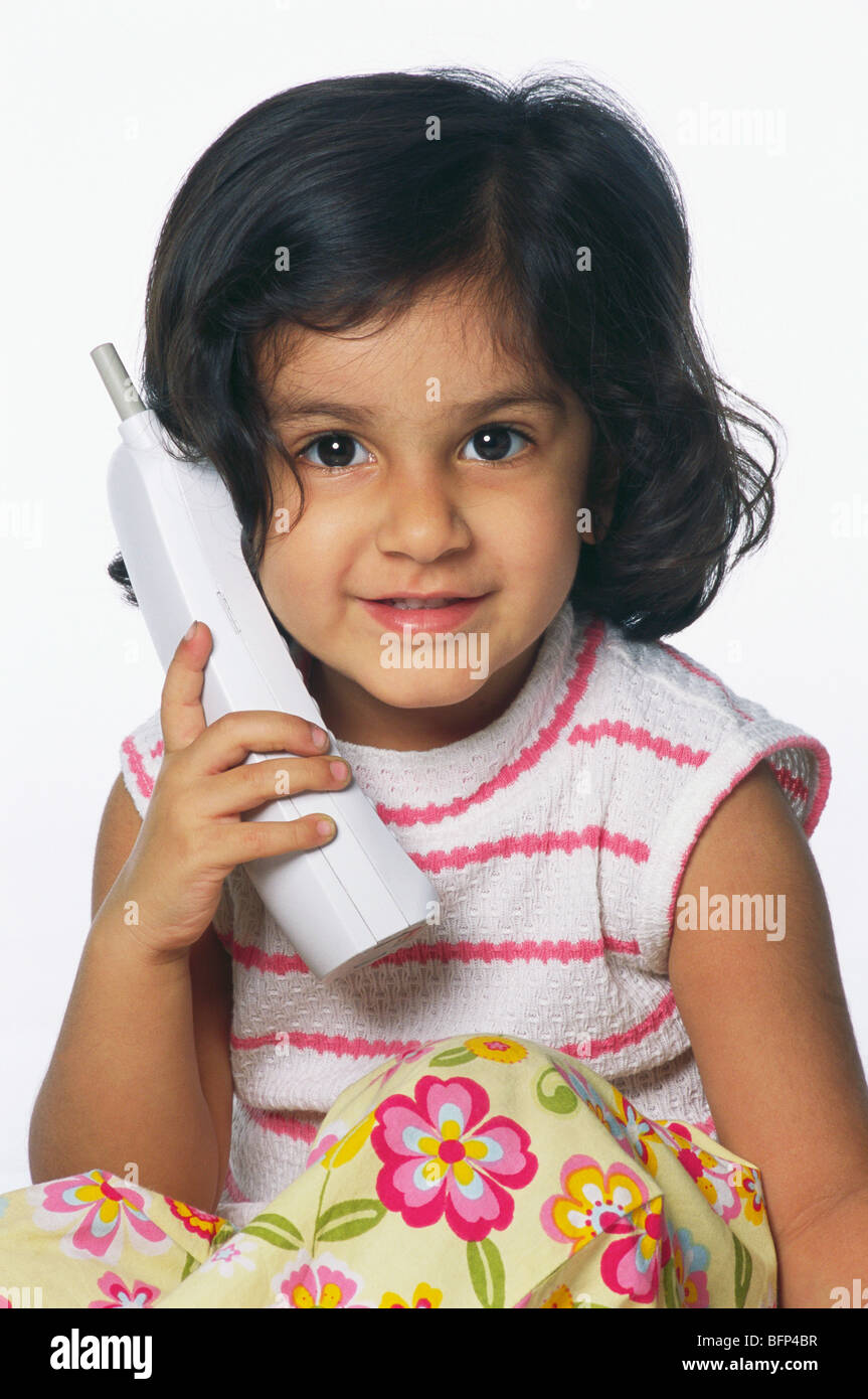 Indian girl child talking on cordless phone ; india ; asia ; MR#372 ...
