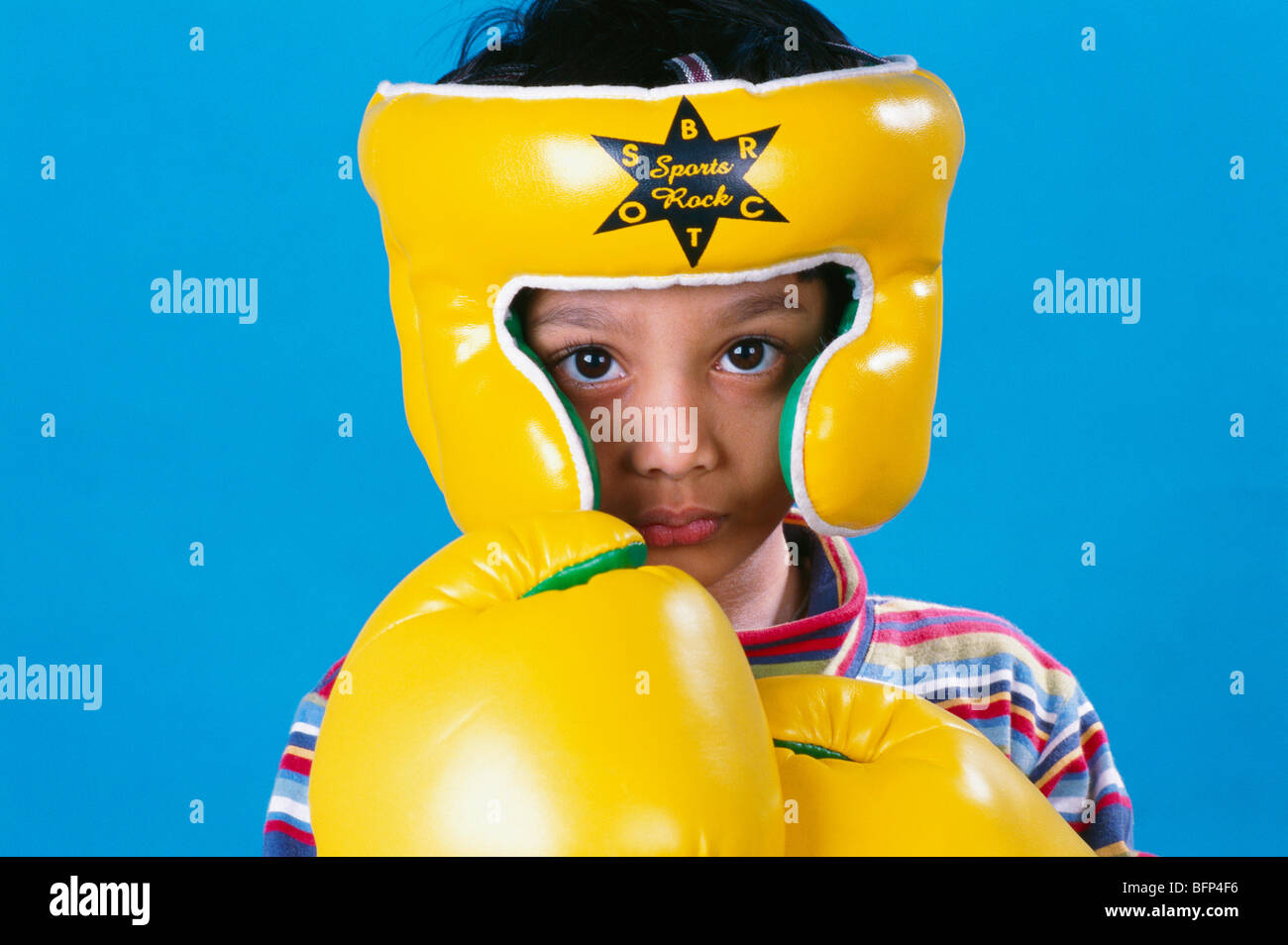 Indian child boy in fancy dress costume of boxer with boxing gloves and ...