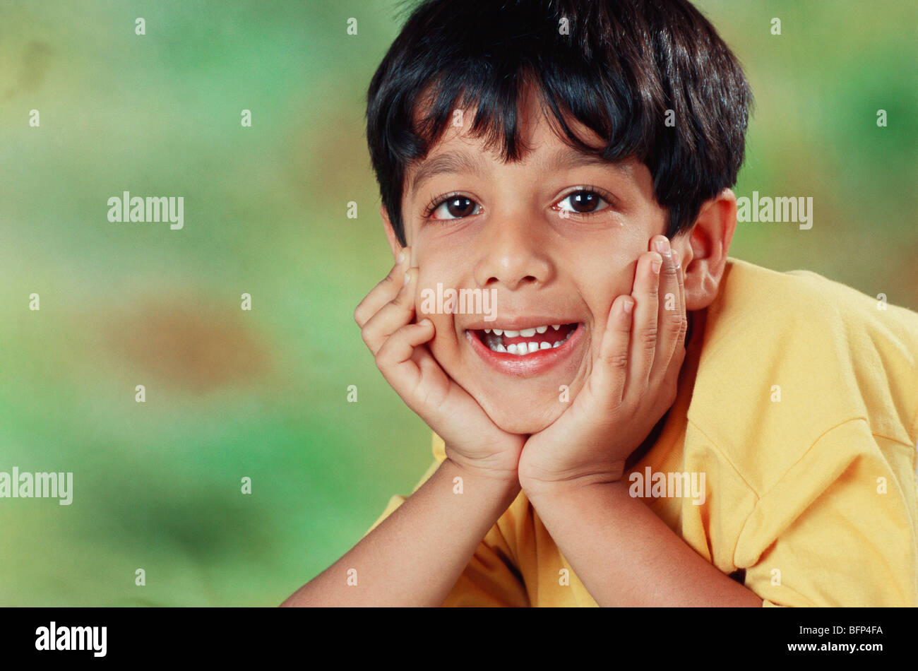 Indian boy child with both hands on cheeks ; india ; asia ; MR#152 ...
