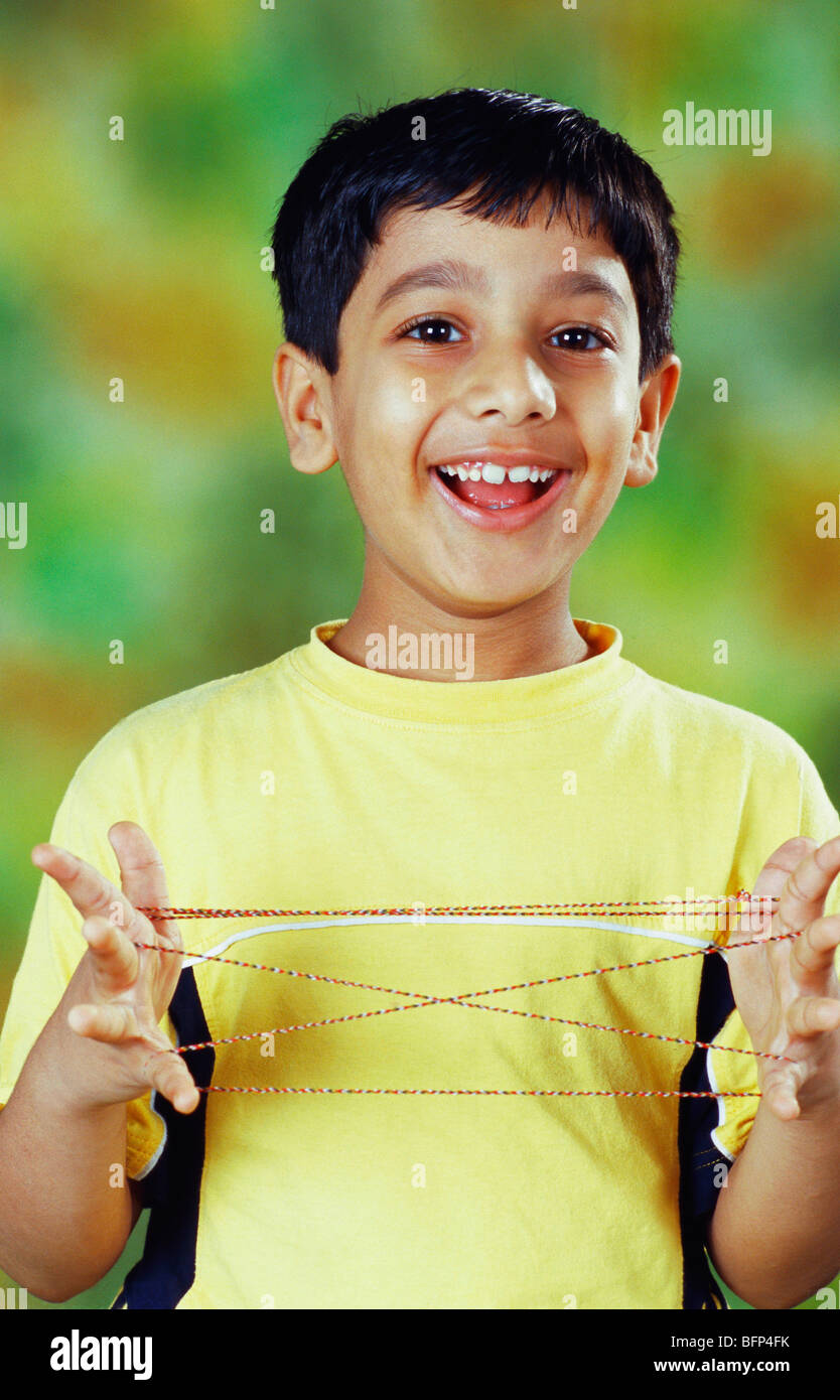 RMM 63607 : Boy playing with thread MR#152 Stock Photo - Alamy