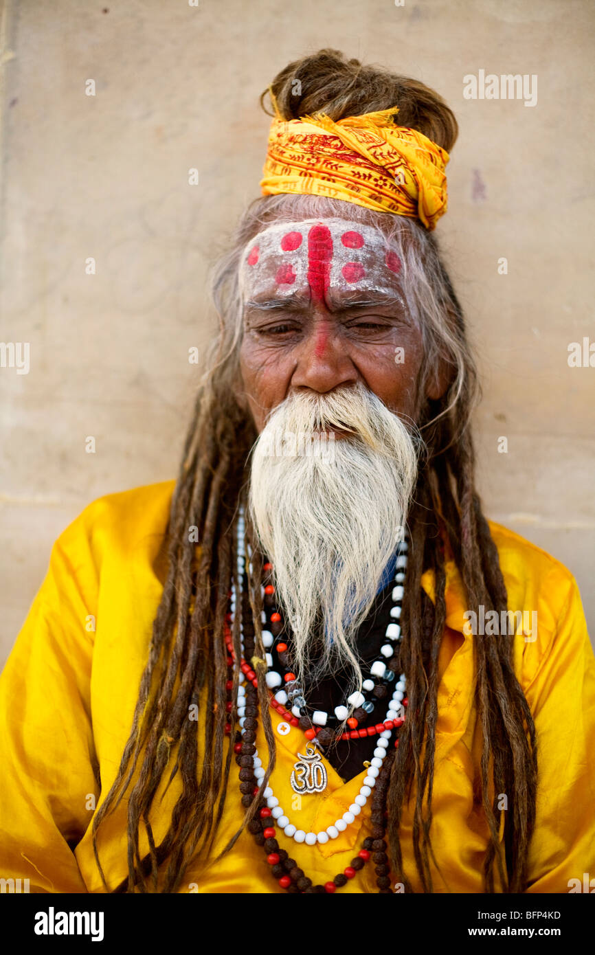 A holy man sits on the Ganges riverfront at the Hindu holy city of ...
