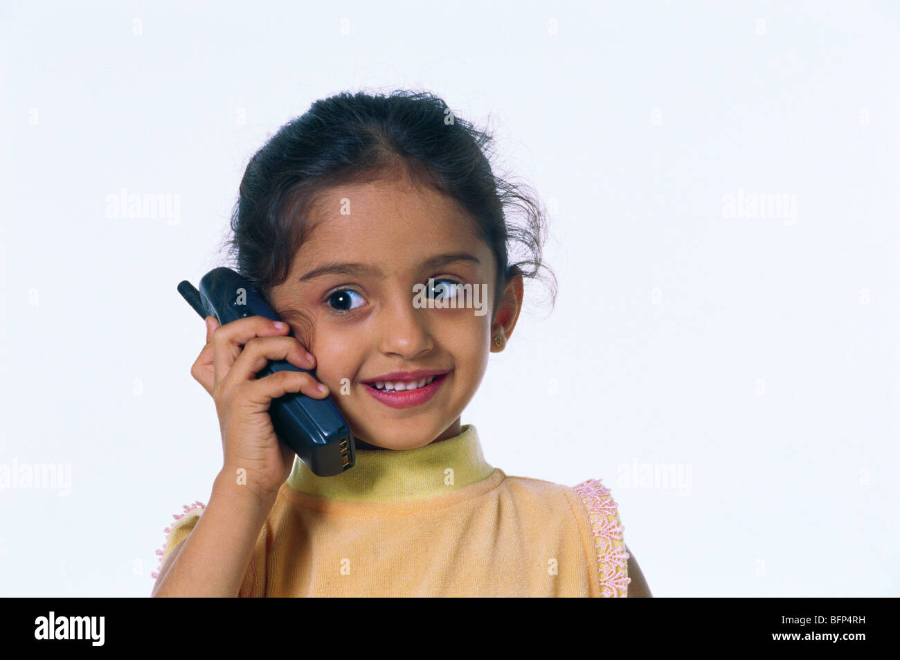 Indian girl child talking on mobile phone ; india ; asia ; MR#235 Stock ...