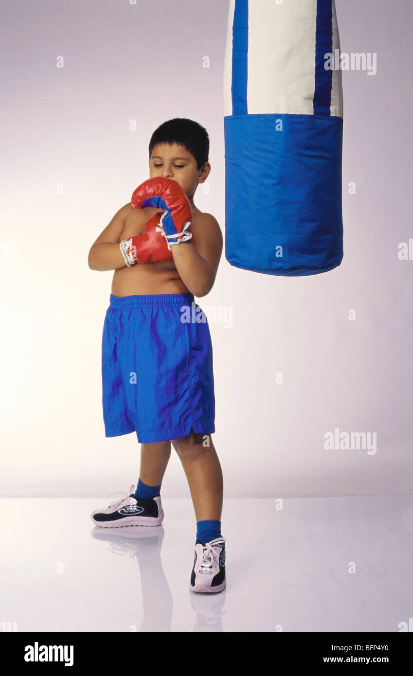 Indian child boy in fancy dress costume of boxer wearing boxing gloves ...