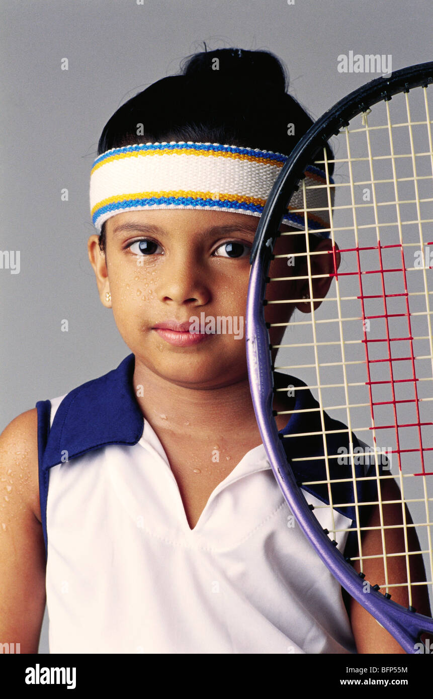 Indian child girl in fancy dress costume of tennis player with racket ...