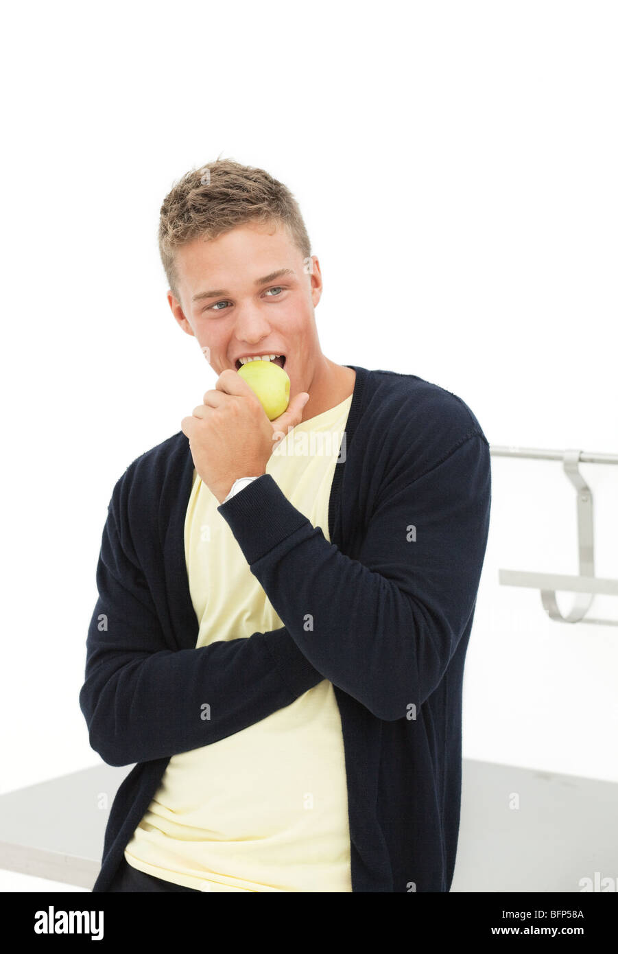handsome blond man eating apple; isolated on white Stock Photo - Alamy