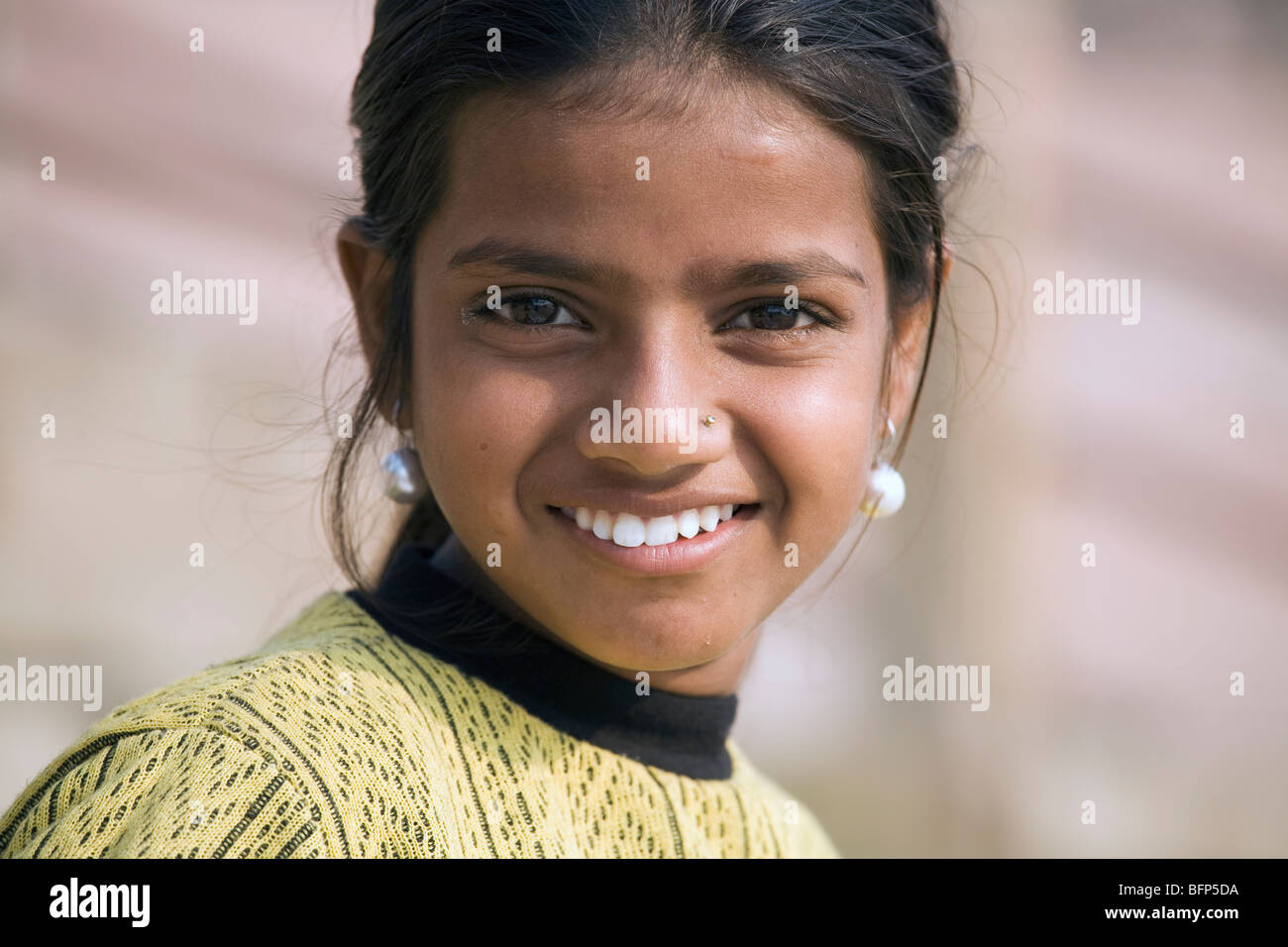 A young girl at the Ganges riverside in the Hindu holy city of Varanasi ...