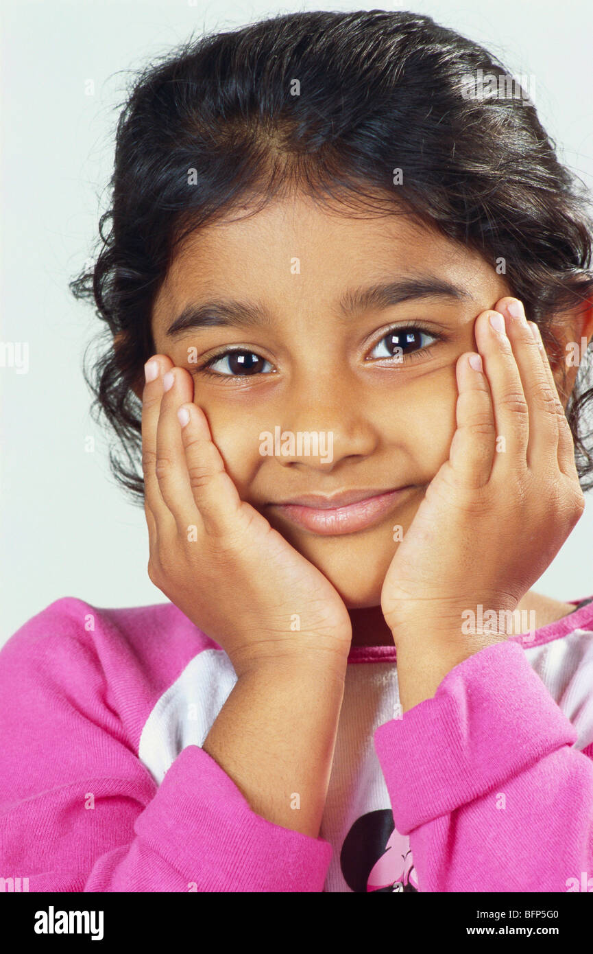Indian child girl with both hands on both cheeks ; india ; asia ; MR ...