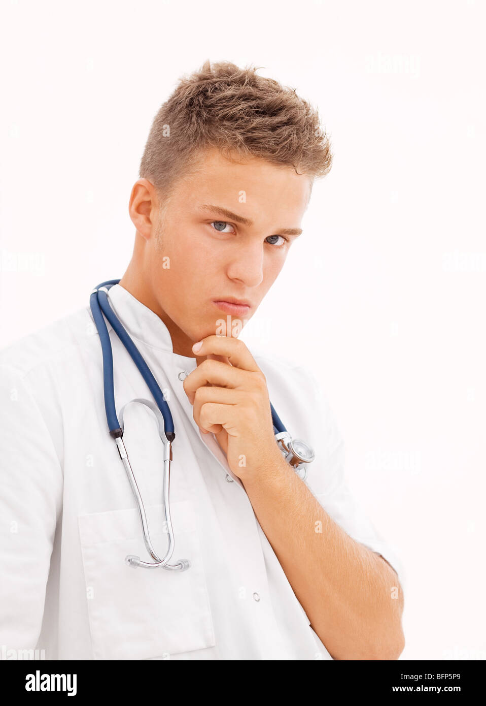 Concerned young blond doctor on white background Stock Photo - Alamy