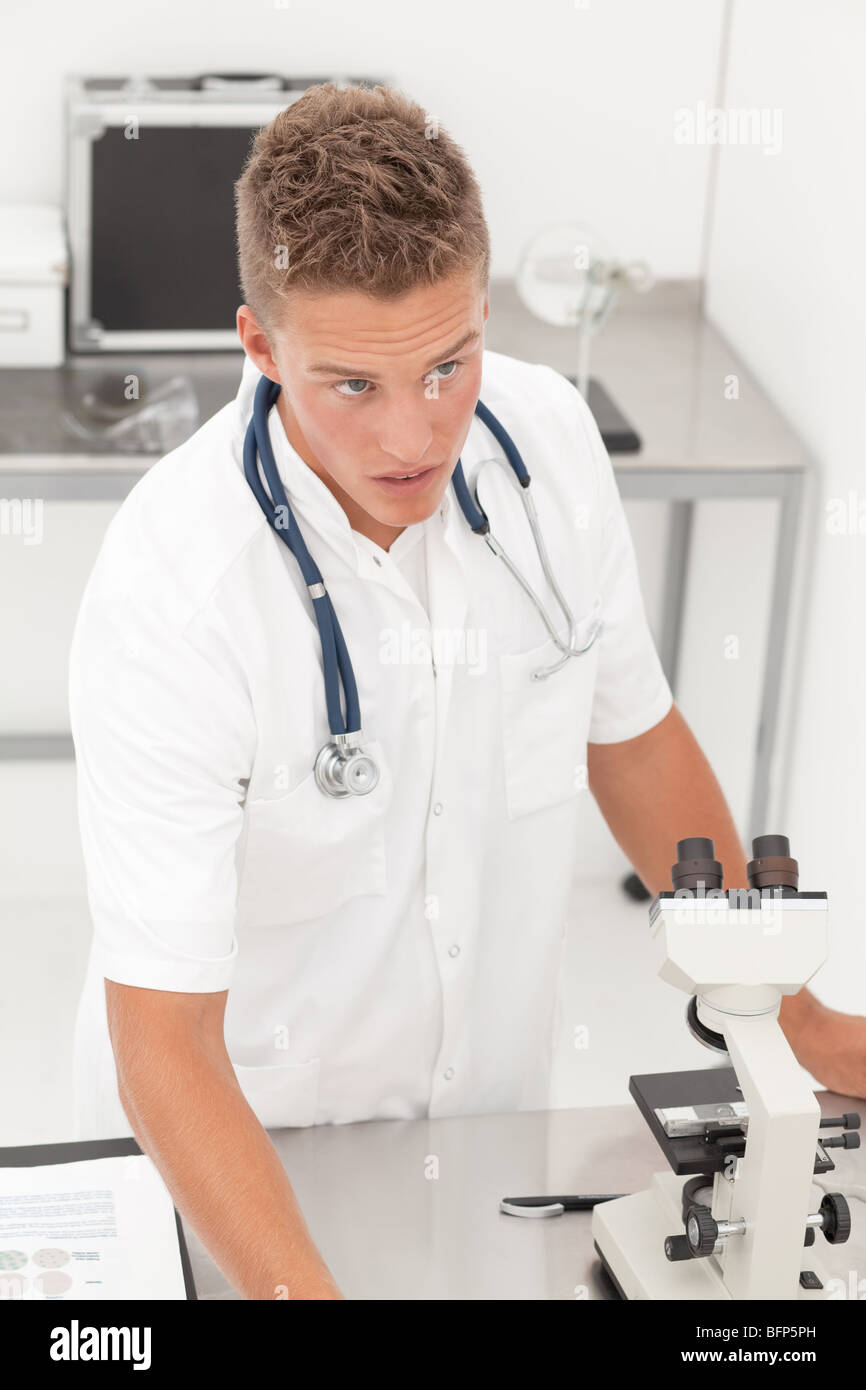 Young blond handsome doctor standing in laboratory Stock Photo - Alamy