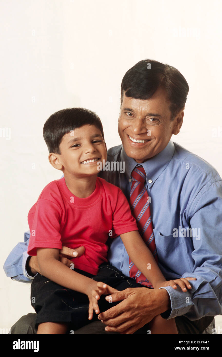 Indian child boy Grandson sitting on lap of grandfather ; india ; asia ...