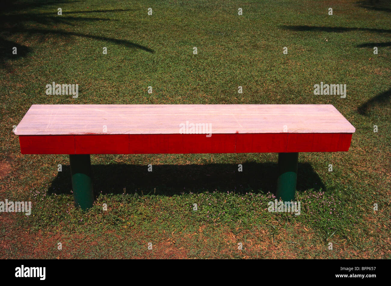 Red bench on green grass Stock Photo - Alamy